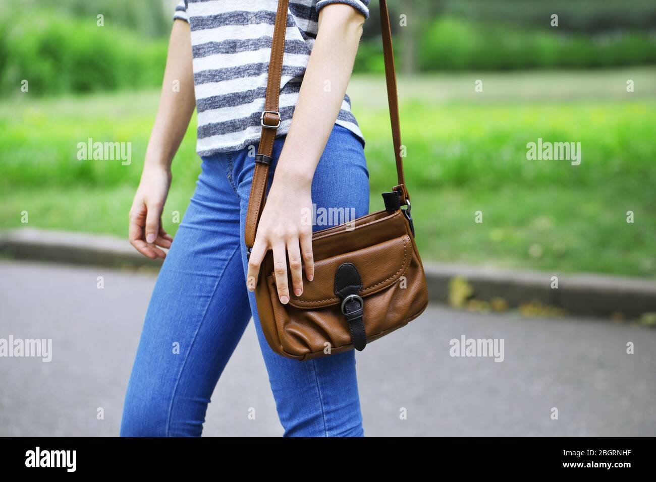 Girl with bag over his shoulder outdoors Stock Photo - Alamy