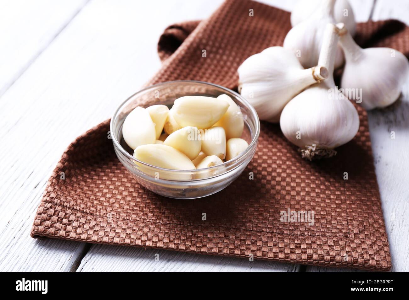 Fresh sliced garlic on wooden background Stock Photo - Alamy