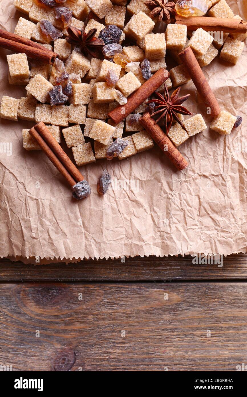 Brown sugar cubes and spices on paper background Stock Photo - Alamy