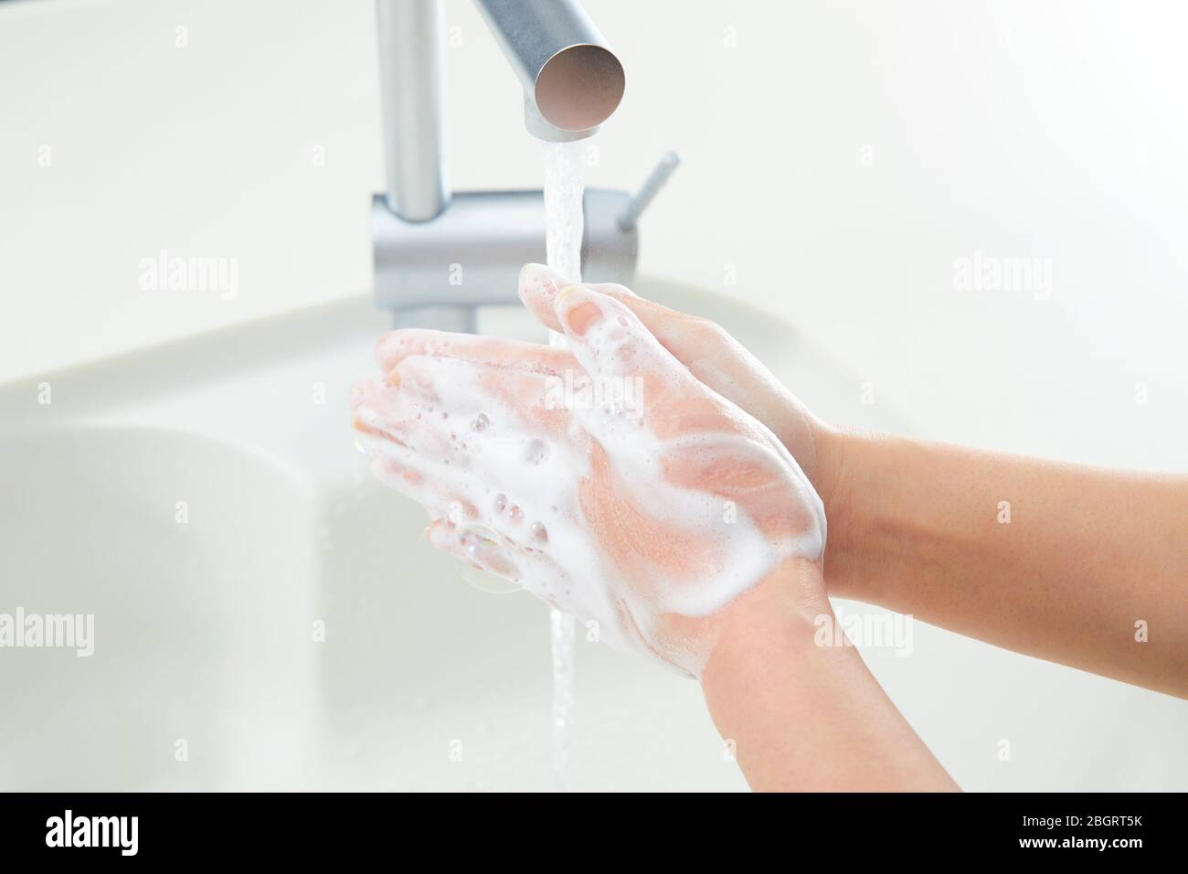 Woman washing hands Stock Photo - Alamy