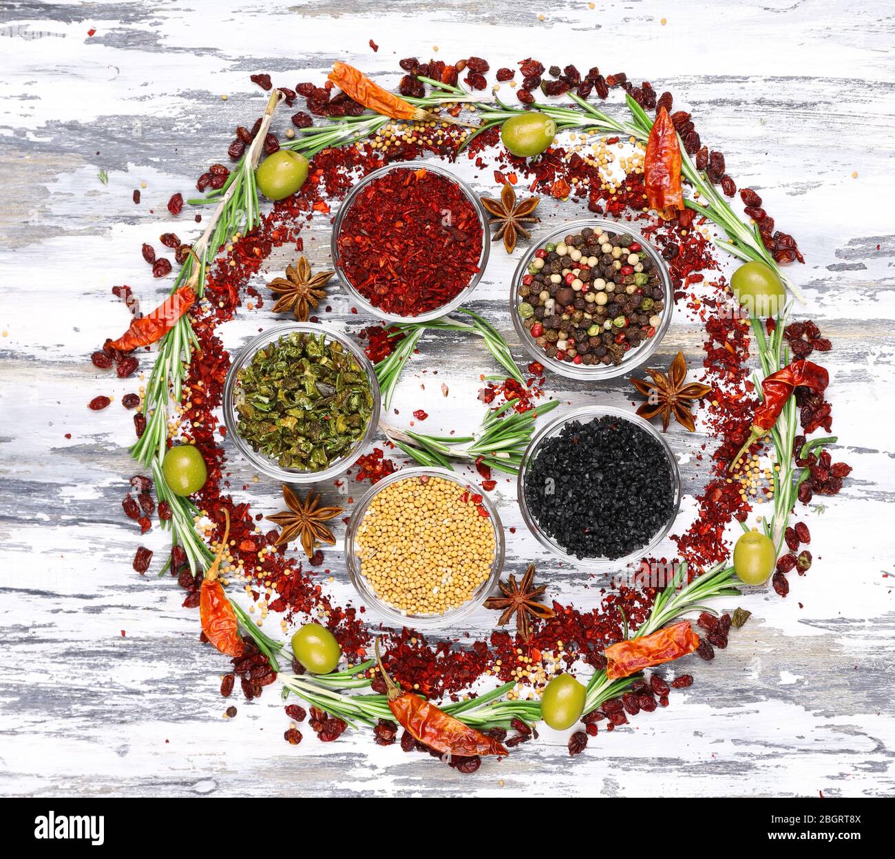 Spices with herbs and dried chilly pepper on wooden background Stock ...