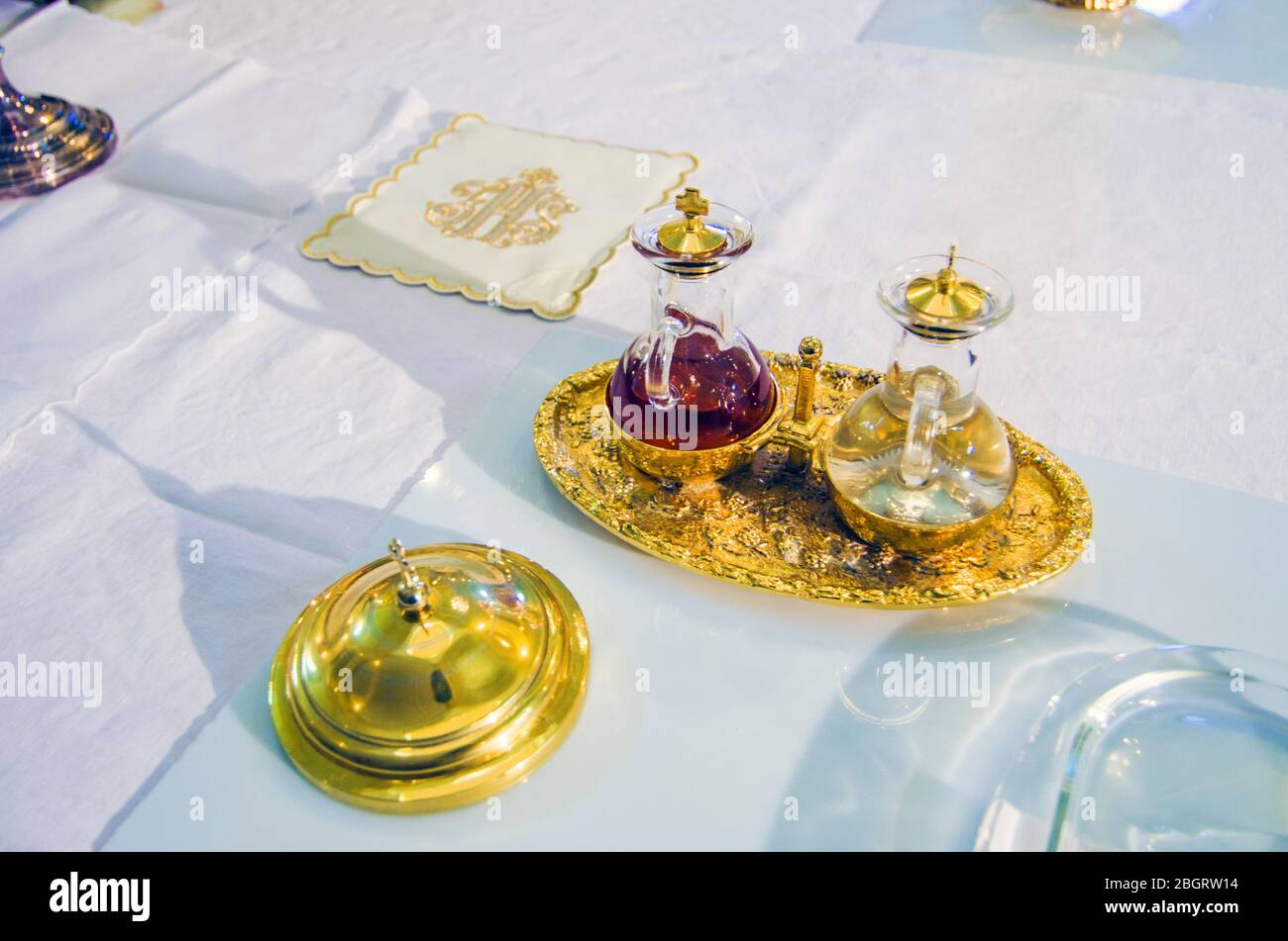 church altar with small wine vial ready to become the blood of jesus ...