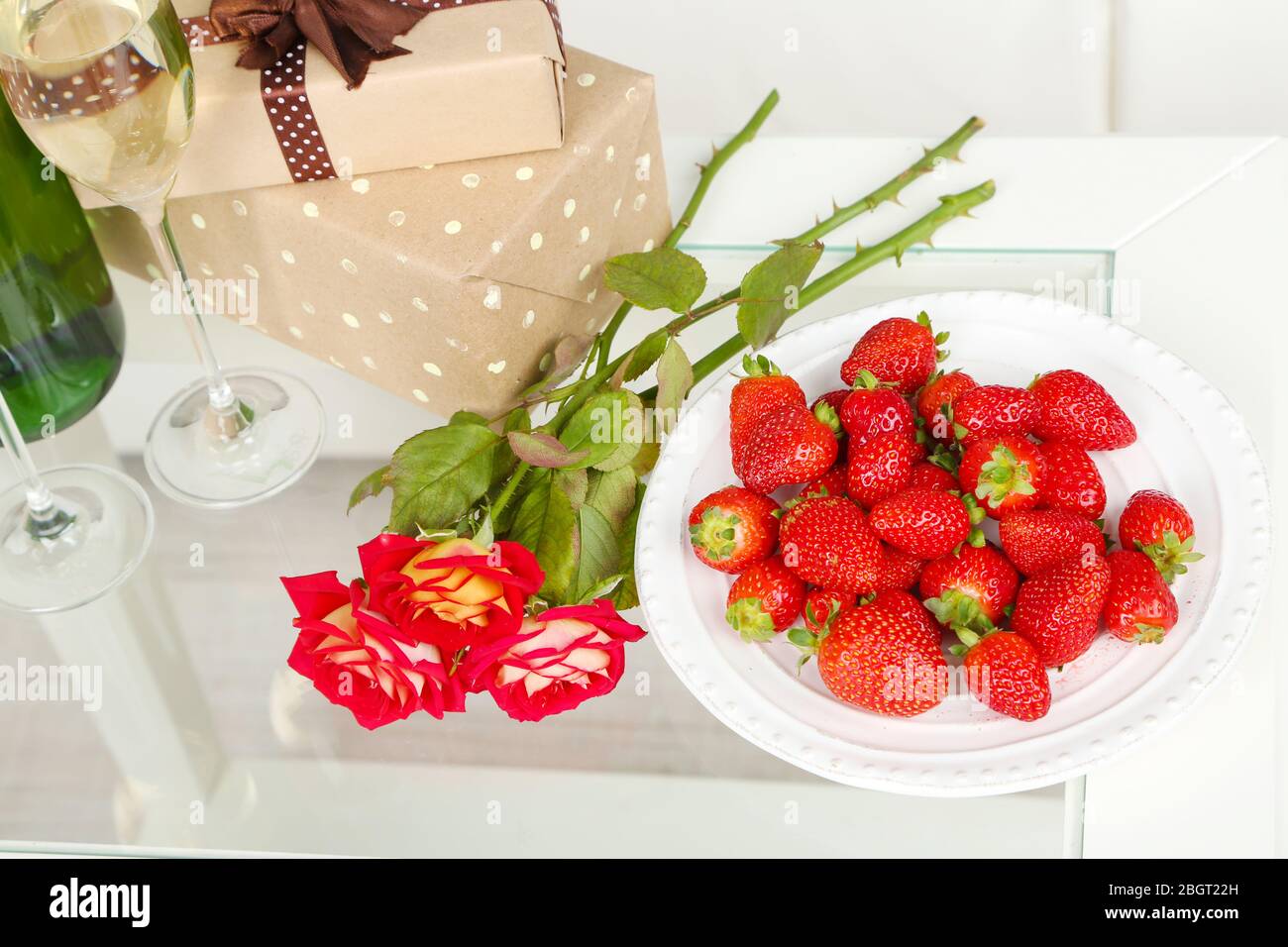 Romantic still life with champagne, strawberry and roses in room Stock ...