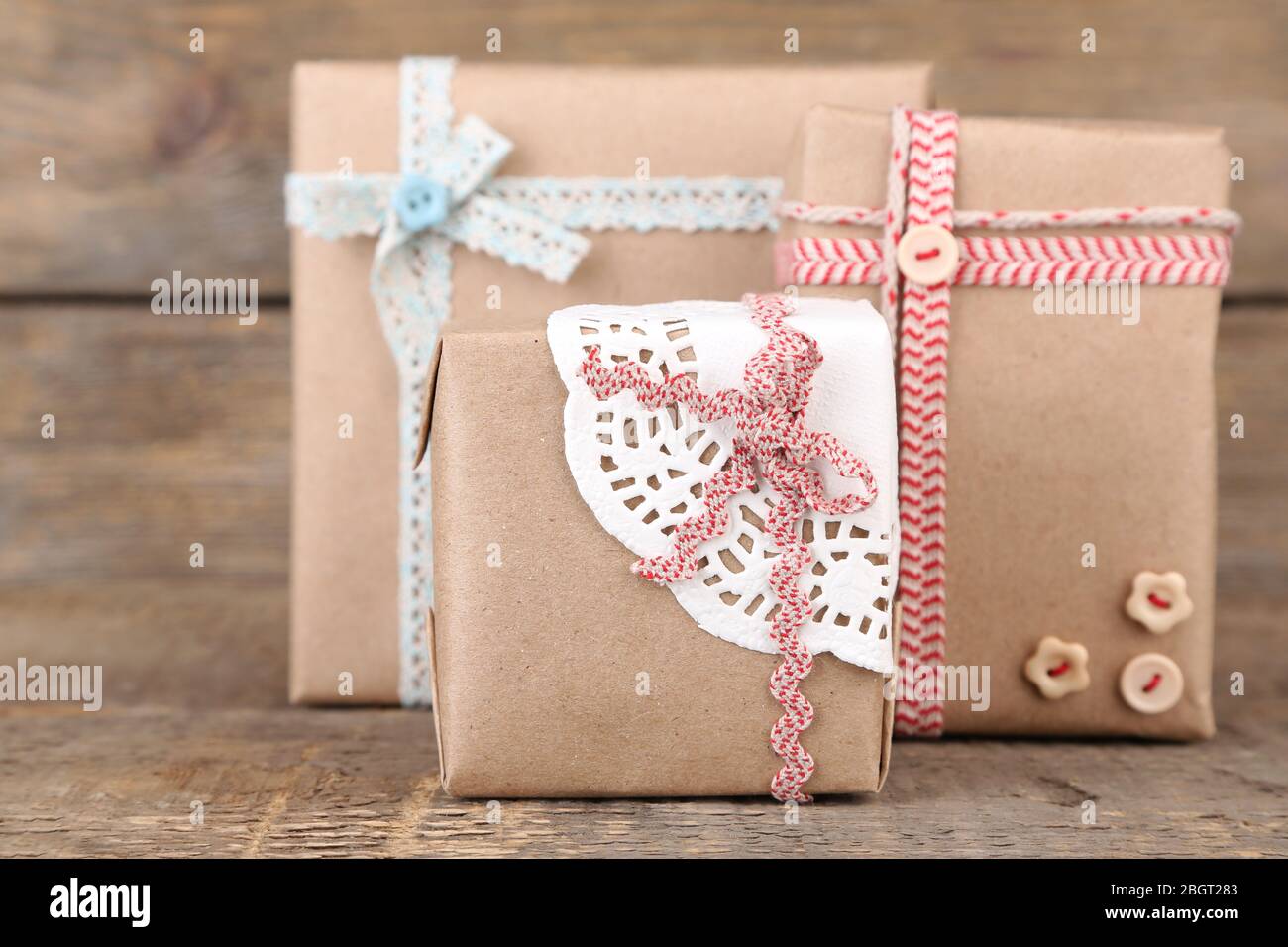 Cute gift boxes on wooden background Stock Photo - Alamy