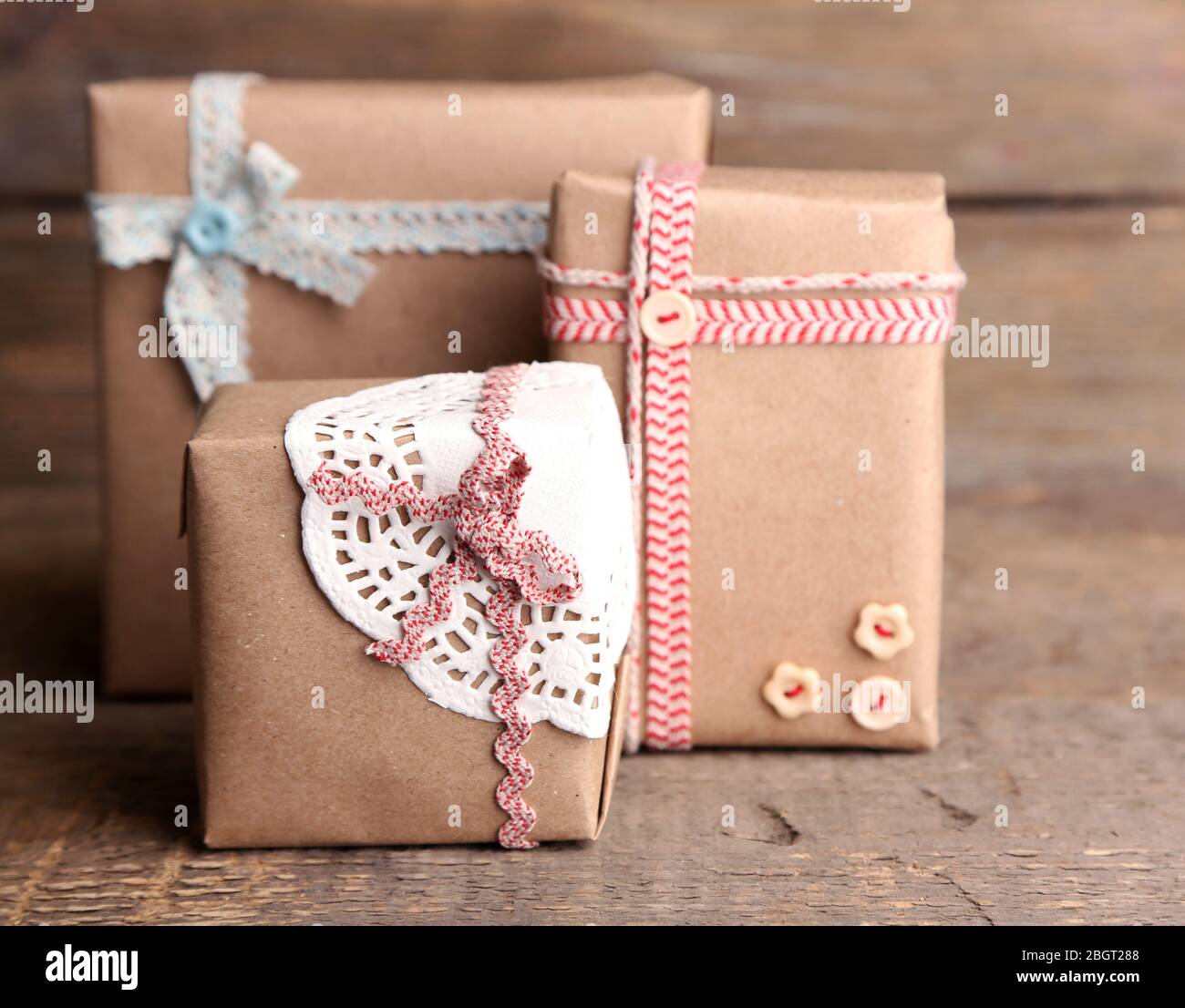 Cute gift boxes on wooden background Stock Photo - Alamy