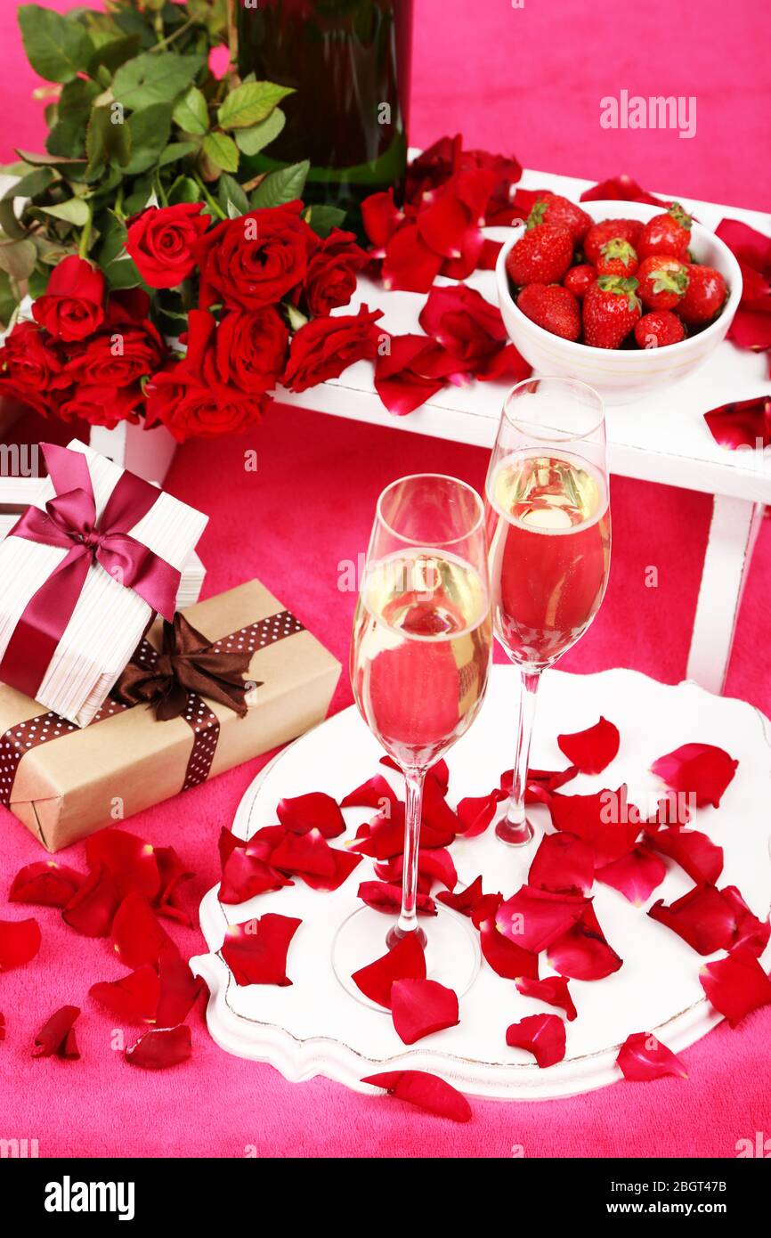 Romantic still life with champagne, strawberry and roses on bed Stock ...