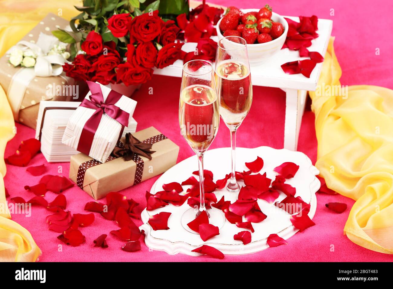 Romantic still life with champagne, strawberry and roses on bed Stock ...
