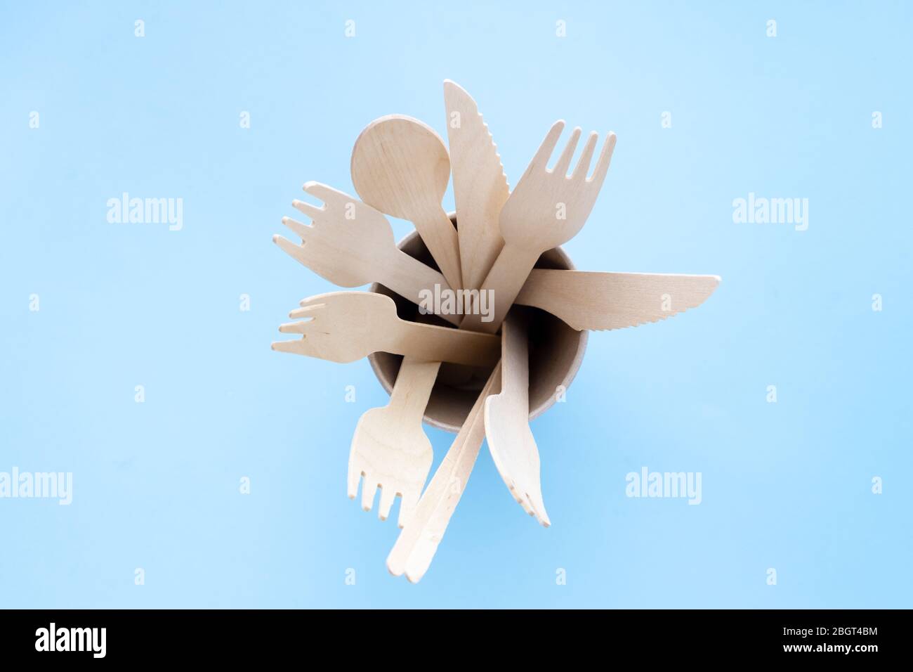 eco friendly disposable kitchenware utensils on blue background. wooden ...