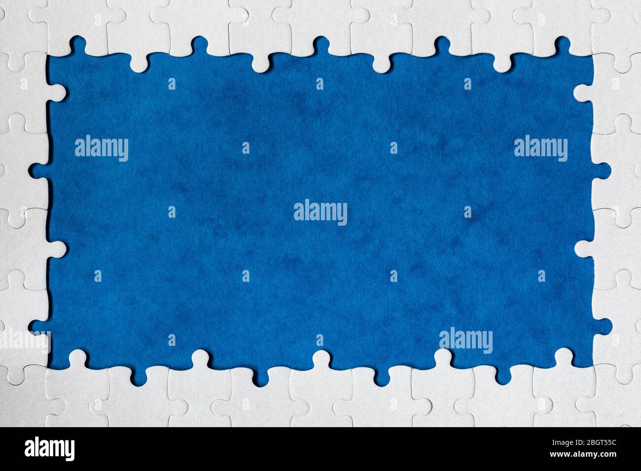 Framing in the form of a rectangle, made of a white jigsaw puzzle ...