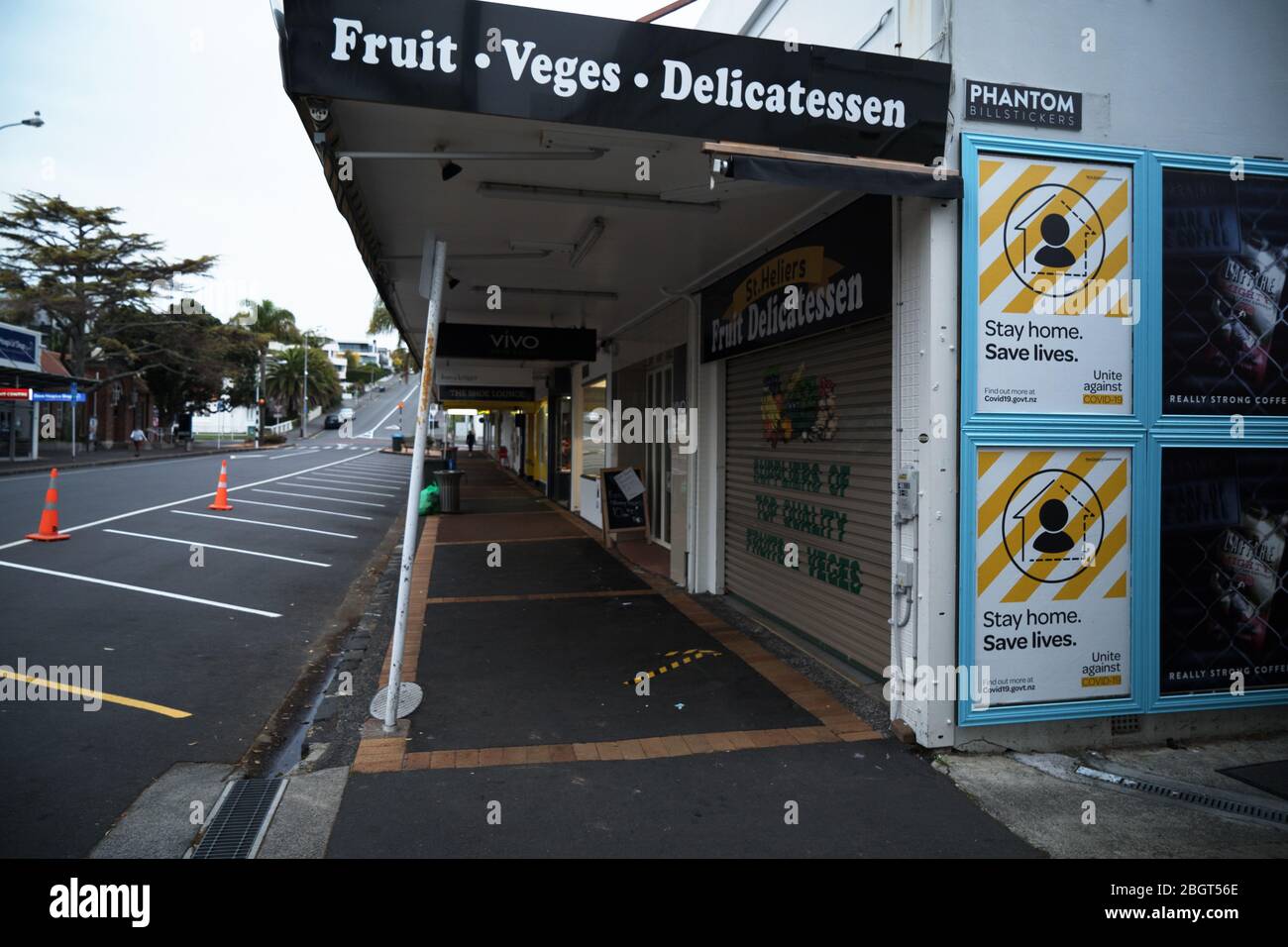 Stay home save lives poster on a billboard and closed shops and empty ...