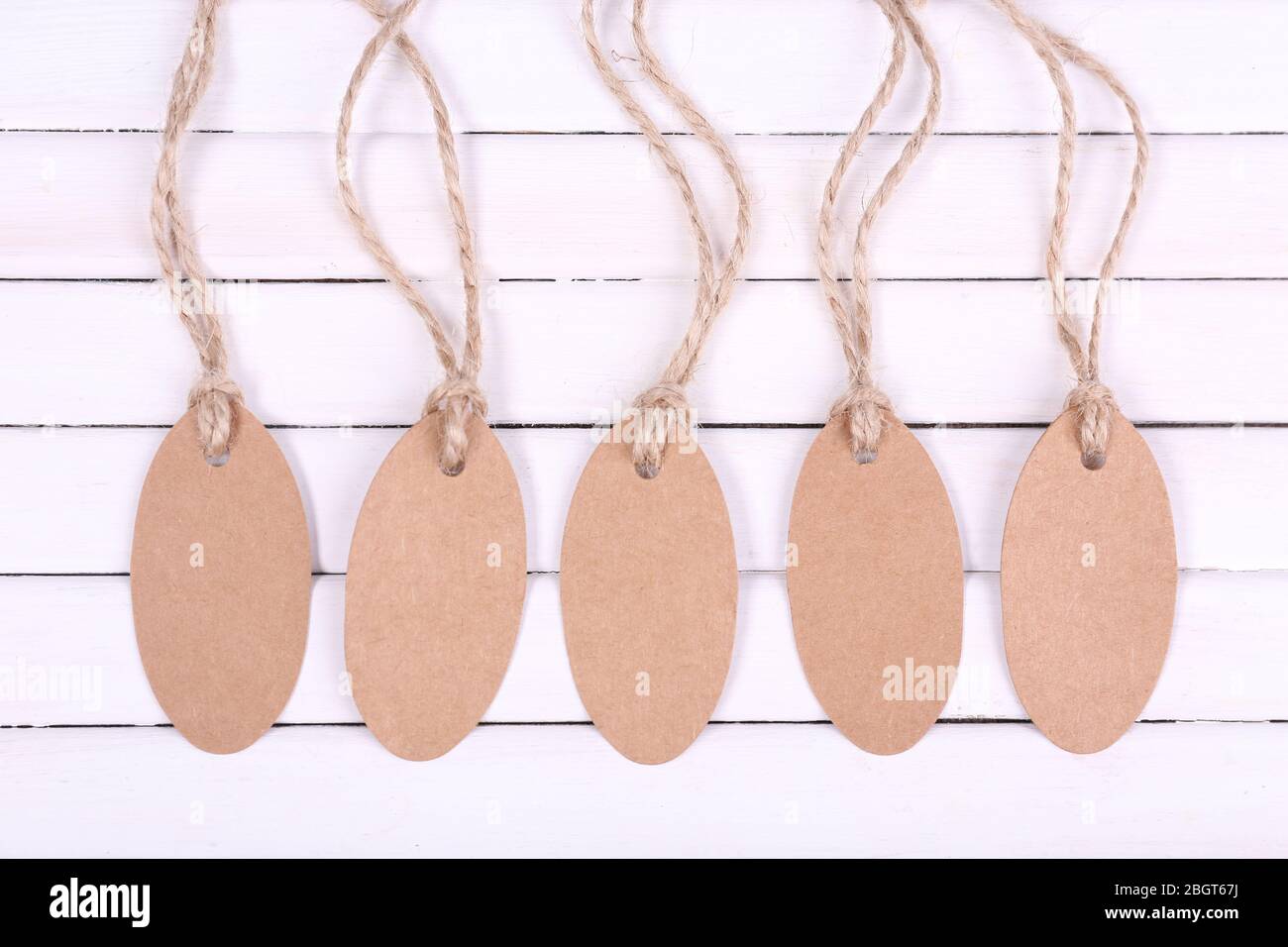empty tags on white wooden background Stock Photo - Alamy
