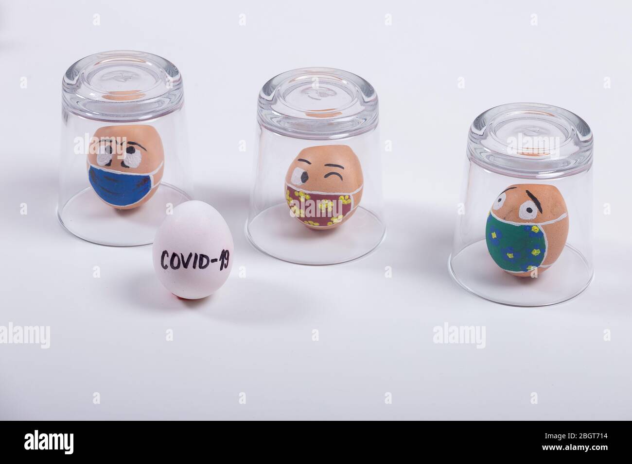 The concept of quarantine at Easter time. Easter painted eggs in glass ...