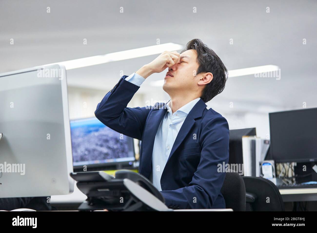 Tired Japanese businessman in the office Stock Photo - Alamy