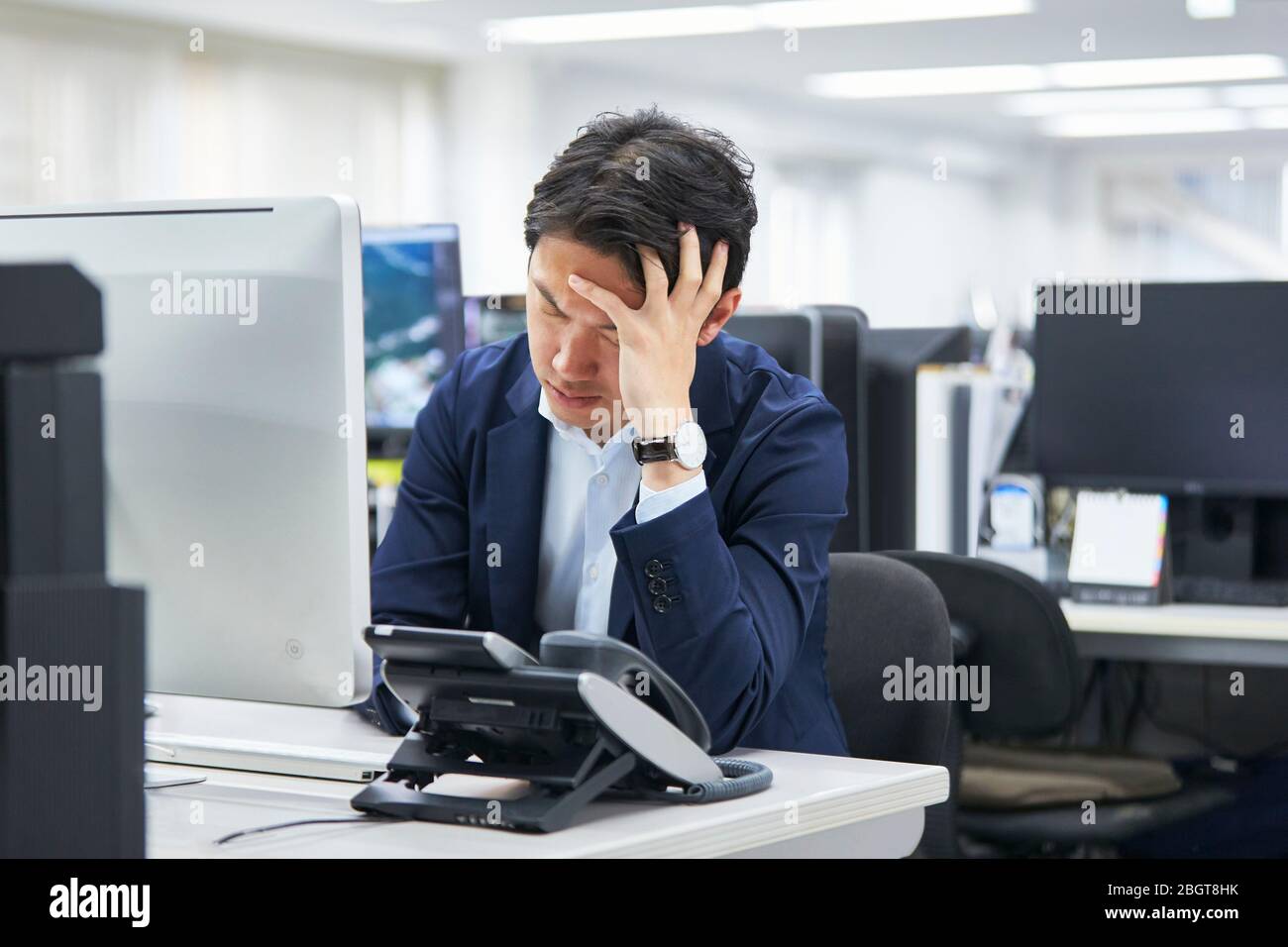 Tired Japanese businessman in the office Stock Photo - Alamy