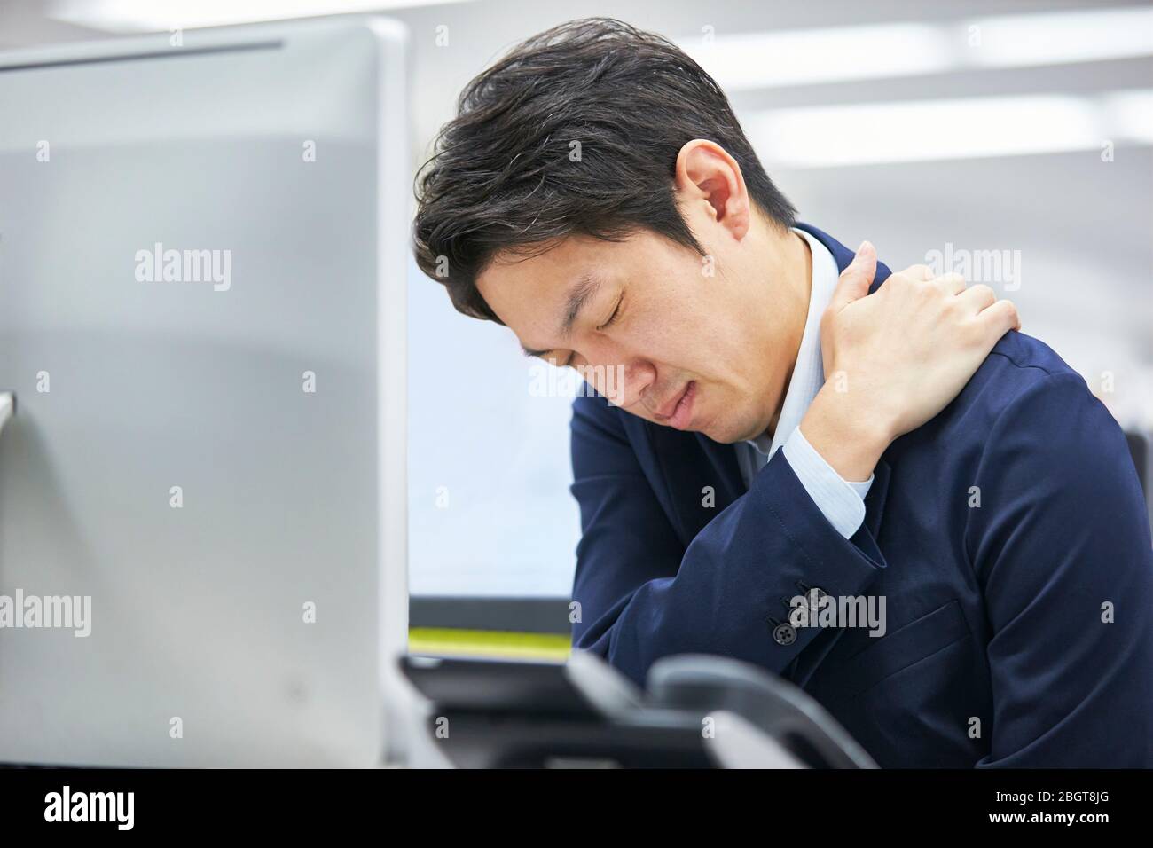 Tired Japanese businessman in the office Stock Photo - Alamy