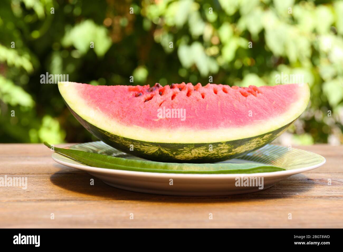 Fresh slice of watermelon on table outdoors, close up Stock Photo - Alamy