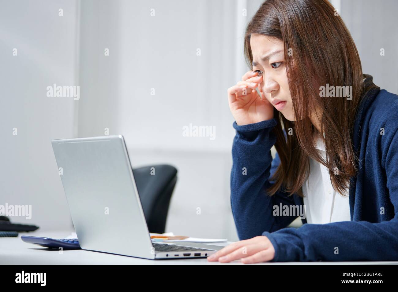 Tired Japanese businesswoman in the office Stock Photo - Alamy