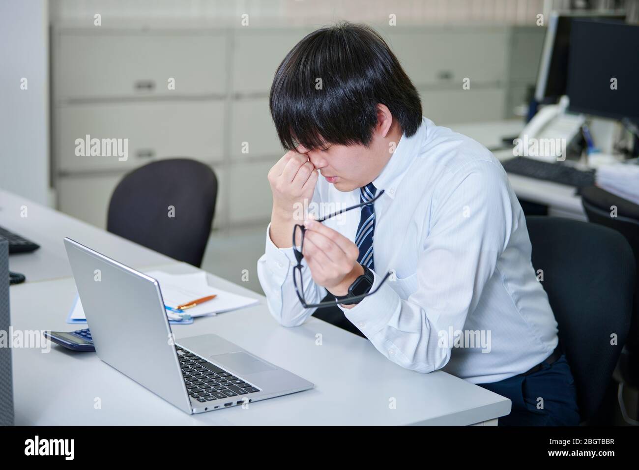 Tired Japanese businessman in the office Stock Photo - Alamy