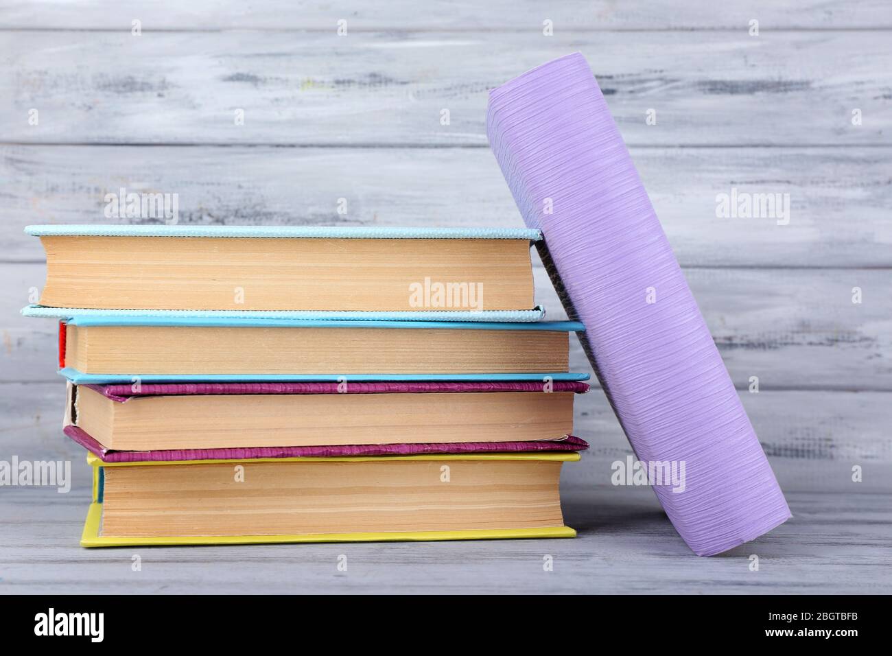 color books on grey wooden background Stock Photo - Alamy