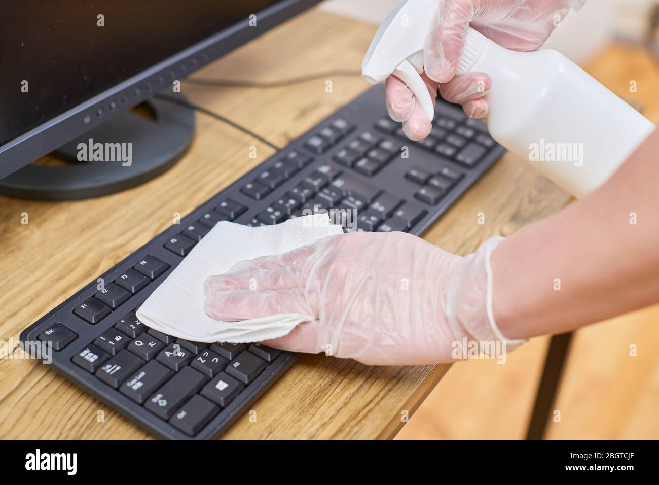 Japan man disinfecting keyboard with alcohol Stock Photo - Alamy