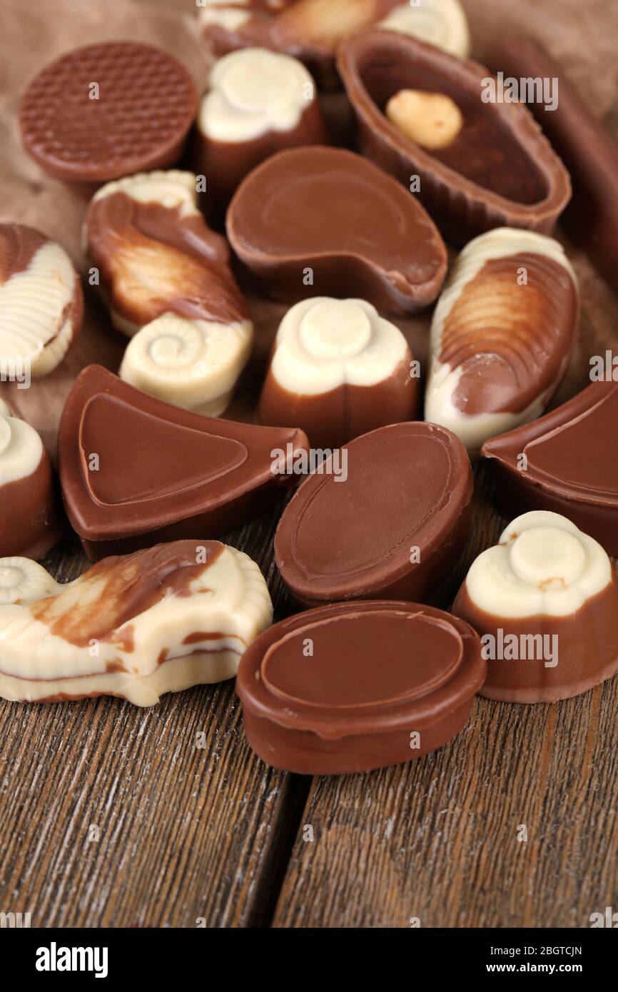 Different kinds of chocolates on wooden table close-up Stock Photo - Alamy