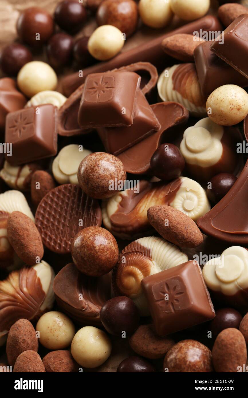 Different kinds of chocolates close-up background Stock Photo - Alamy