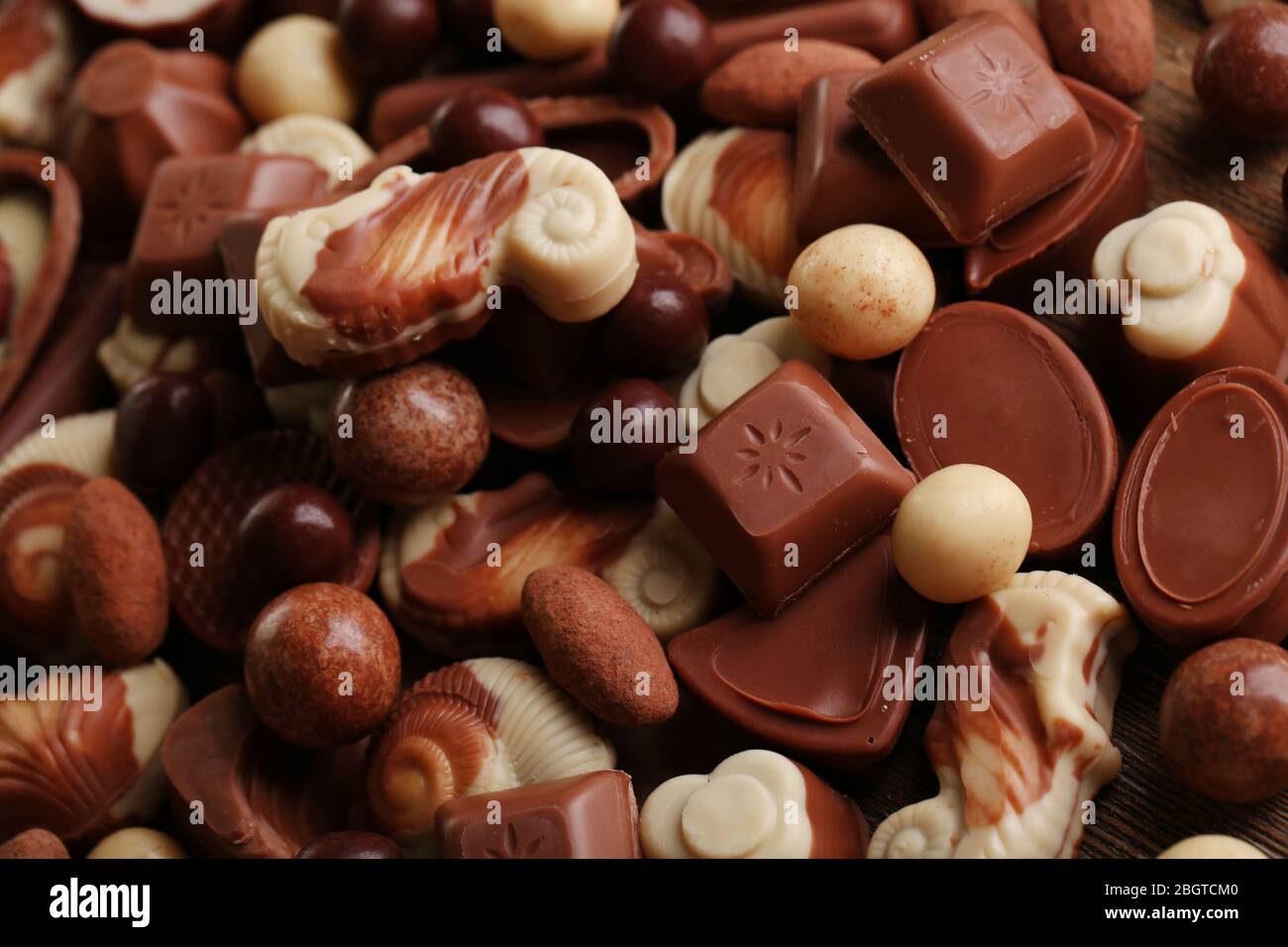 Different kinds of chocolates close-up background Stock Photo - Alamy