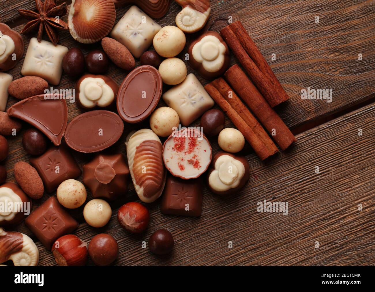 Different kinds of chocolates on wooden table close-up Stock Photo - Alamy