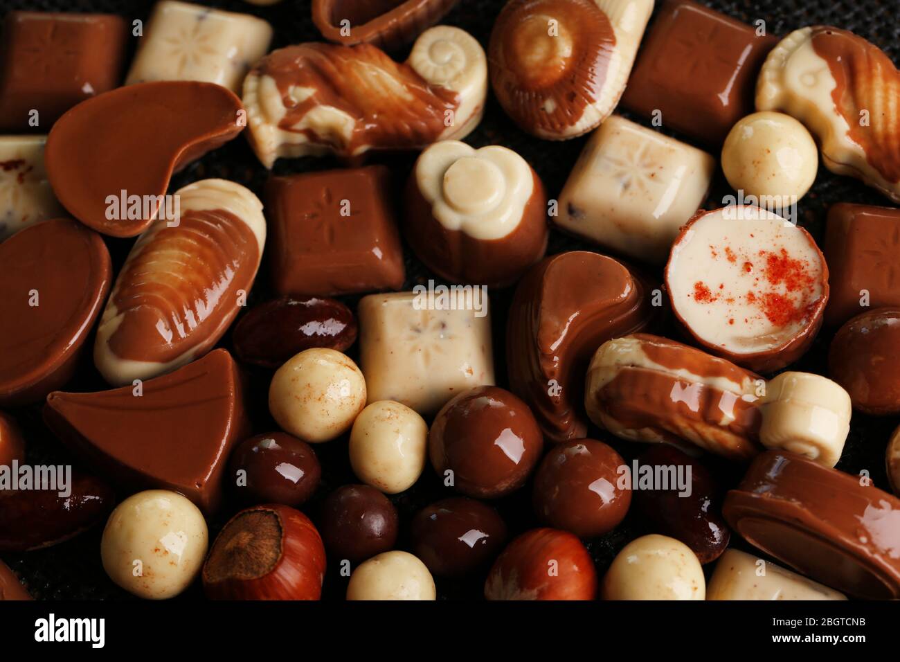 Different kinds of chocolates close-up background Stock Photo - Alamy