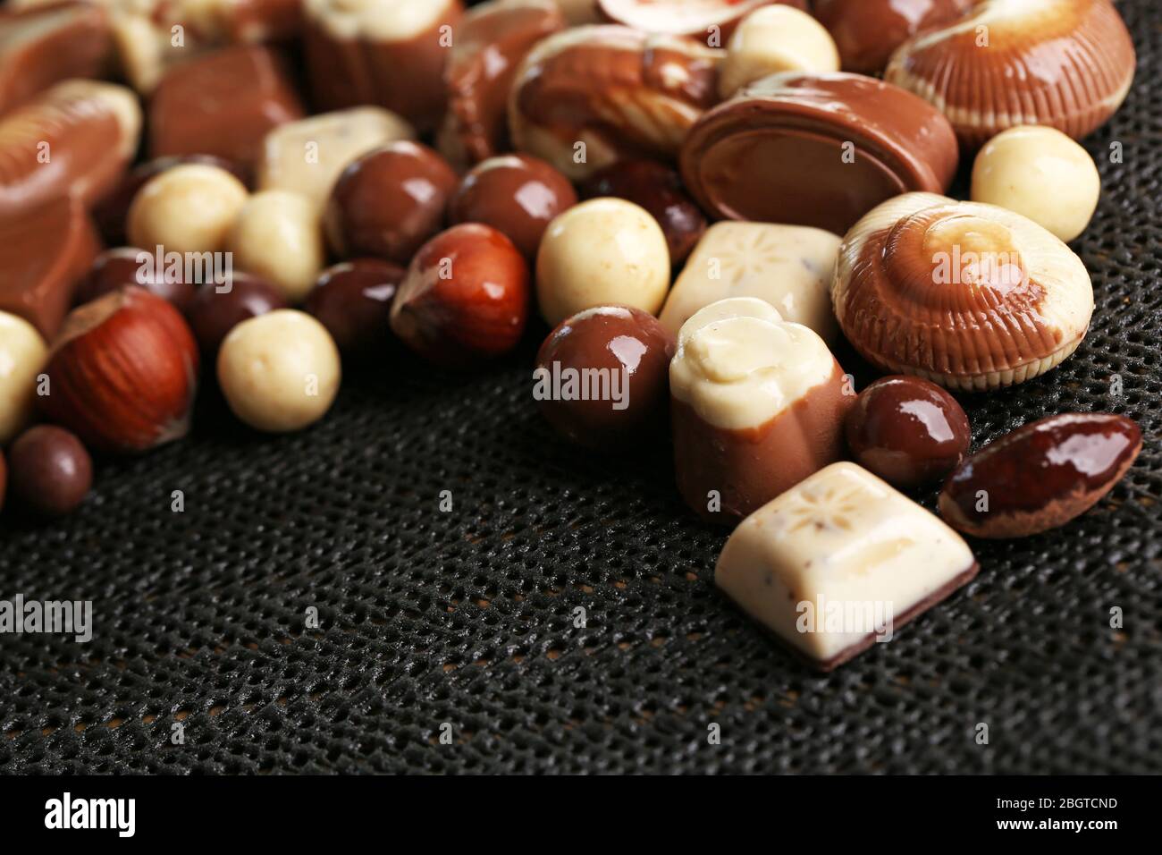 Different kinds of chocolates on dark background Stock Photo - Alamy