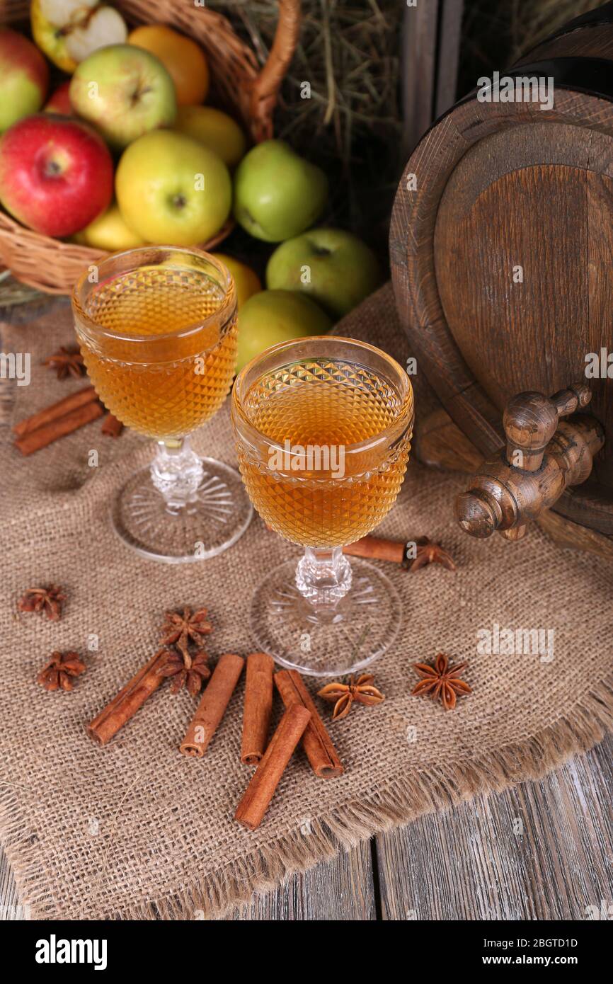 Still life with tasty apple cider in barrel and fresh apples Stock ...