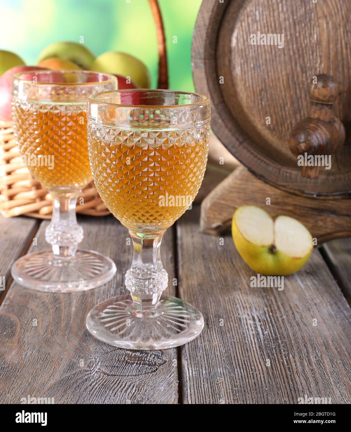 Still life with tasty apple cider and fresh apples, on nature ...