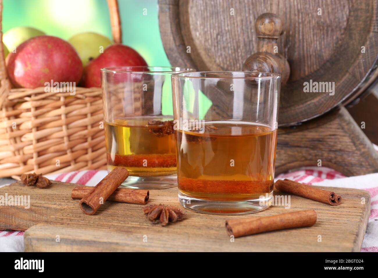 Still life with tasty apple cider and fresh apples, on nature ...