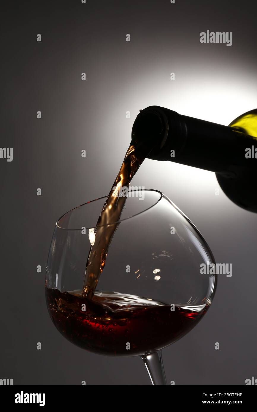 Red wine pouring into wine glass, close-up Stock Photo - Alamy