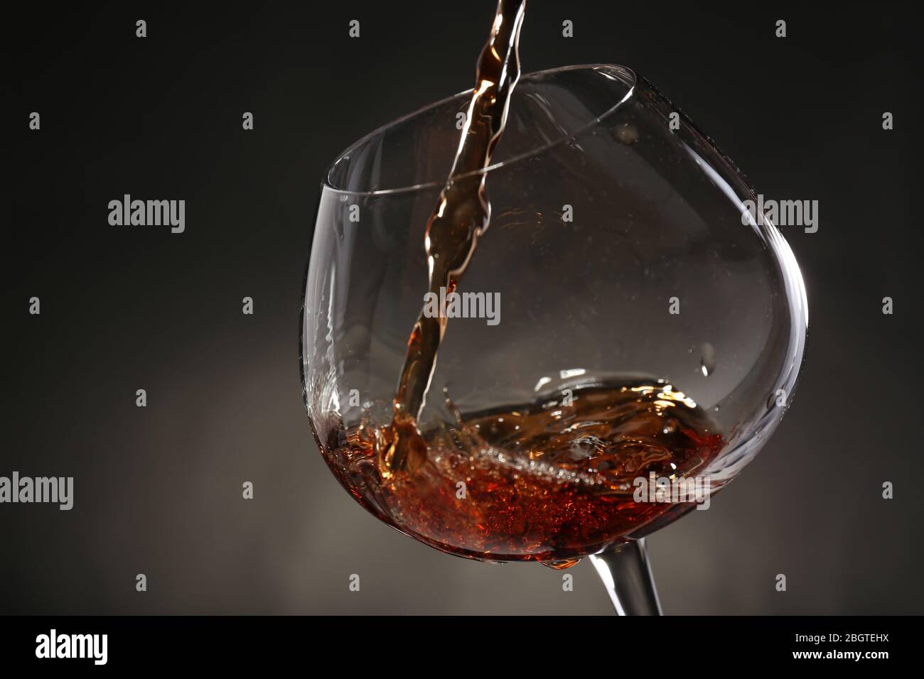 Red wine pouring into wine glass, close-up Stock Photo - Alamy