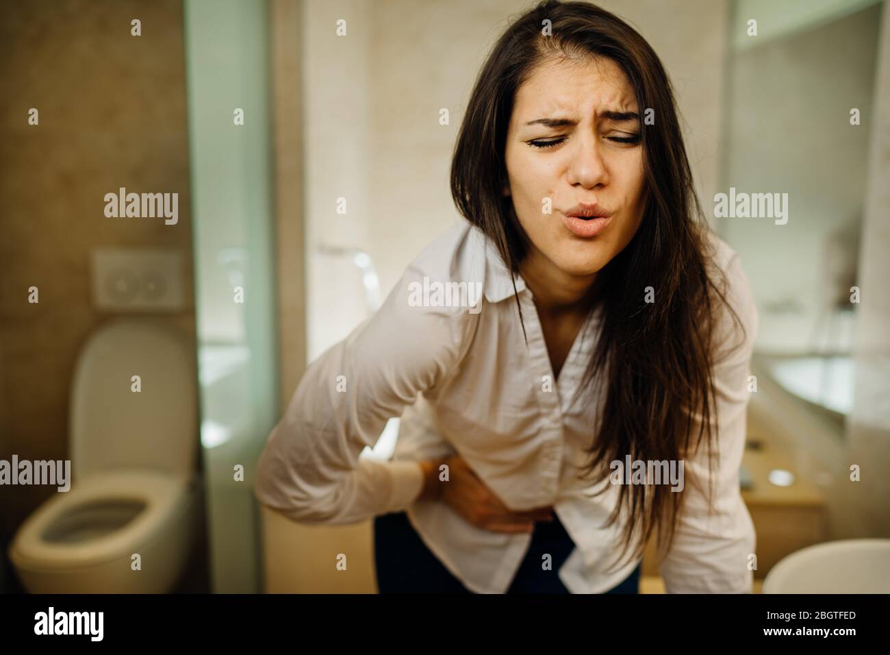 Young woman having severe abdominal menstrual pain.Gastrointestinal ...