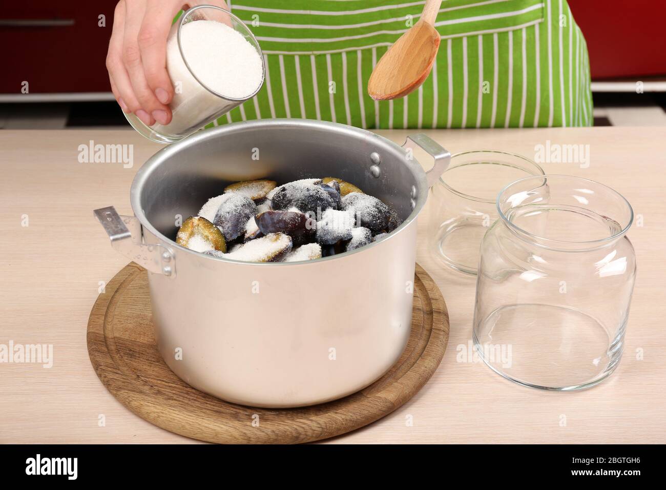 Cooking delicious drain jam in kitchen Stock Photo - Alamy