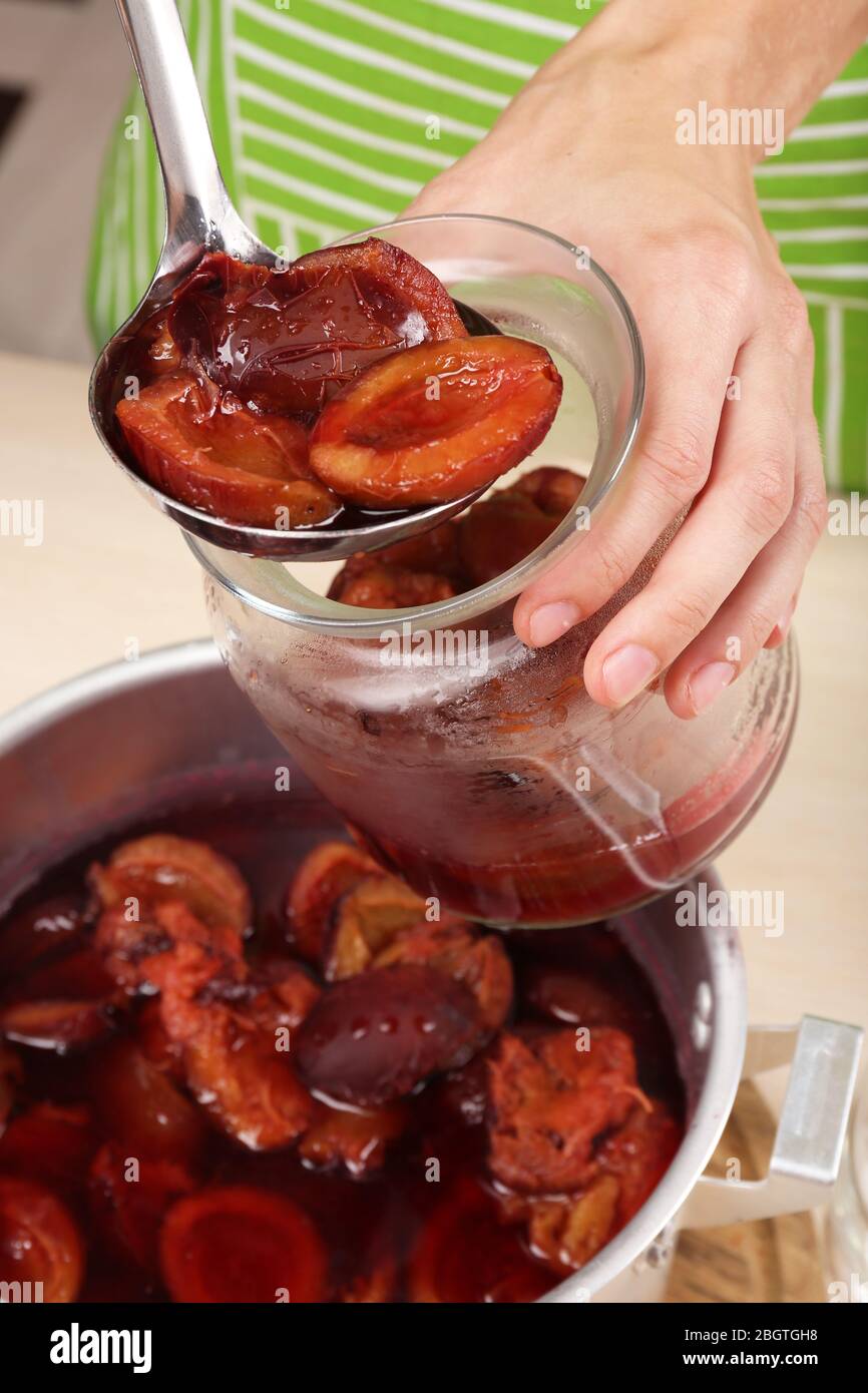 Cooking delicious drain jam in kitchen Stock Photo - Alamy