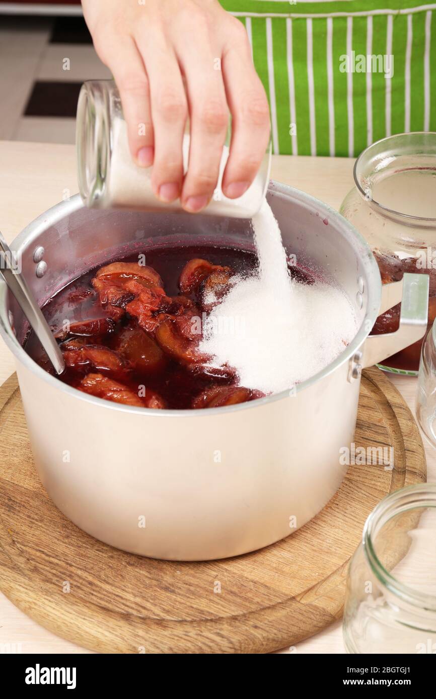 Cooking delicious drain jam in kitchen Stock Photo - Alamy