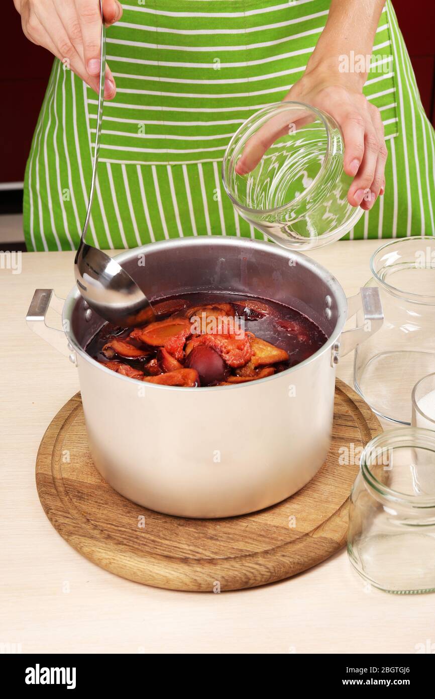 Cooking delicious drain jam in kitchen Stock Photo - Alamy