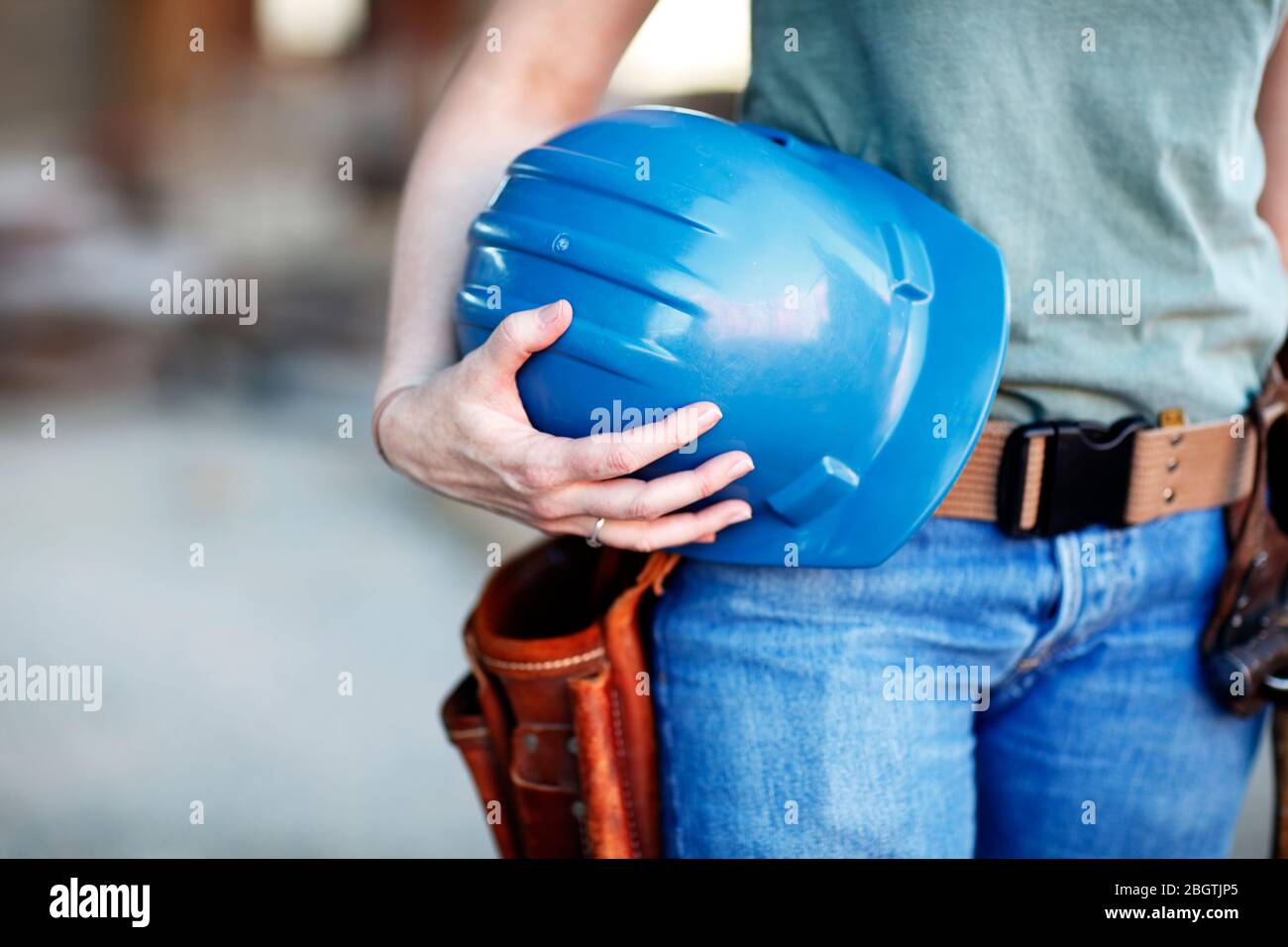 Construction worker holding hard hat hi-res stock photography and ...