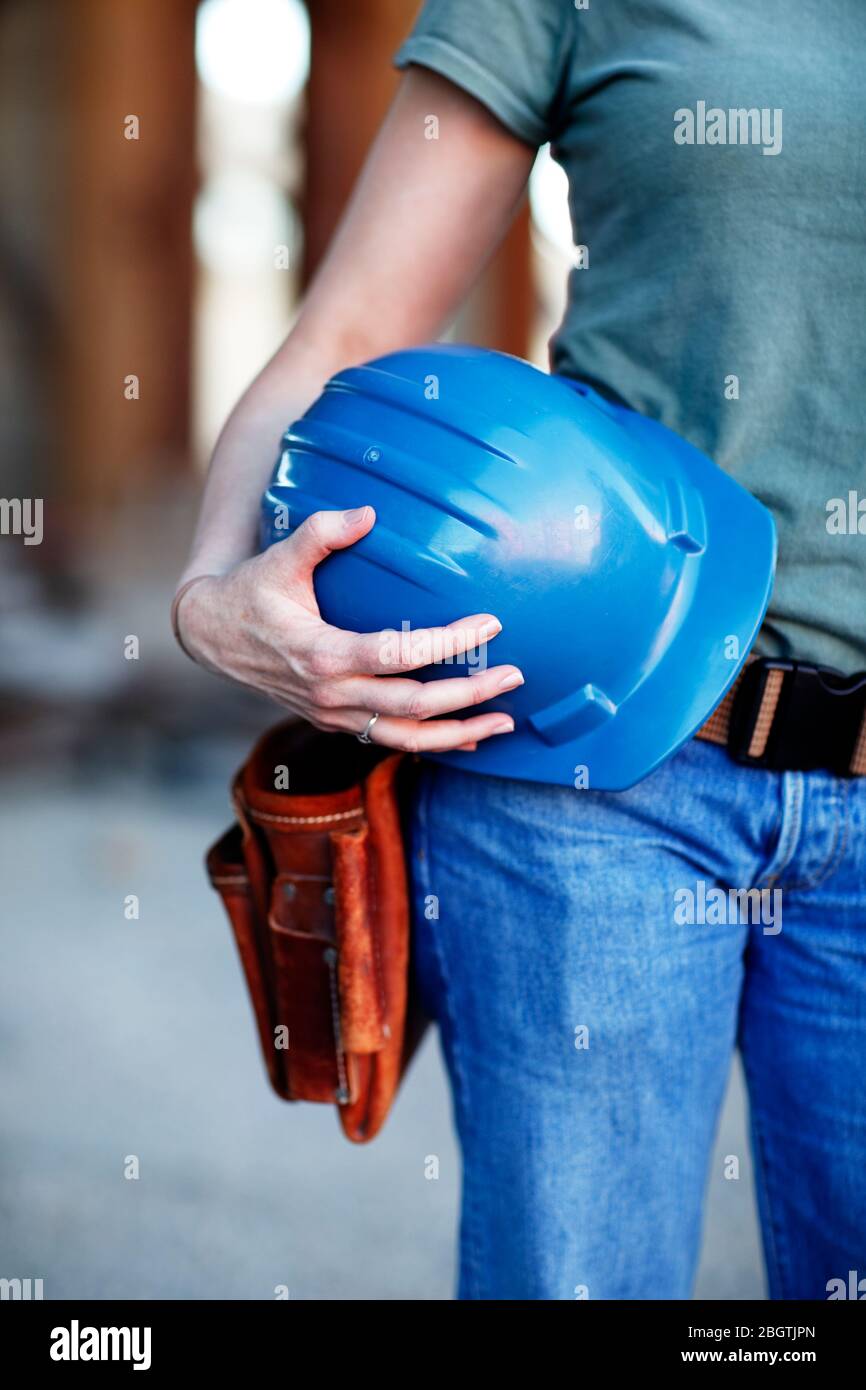Construction worker holding hard hat hi-res stock photography and ...