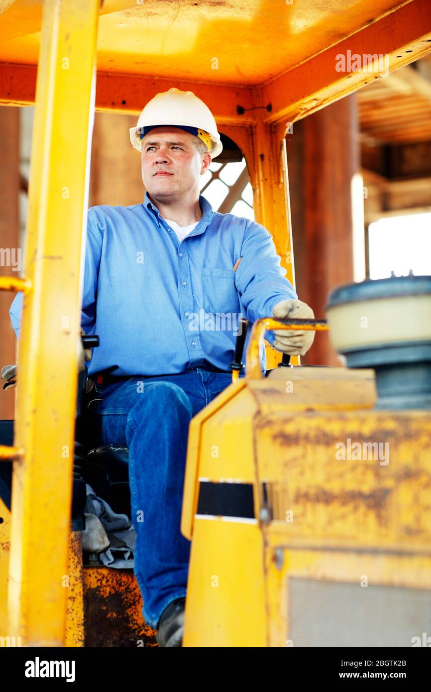 Male construction foreman sitting in a construction loader Stock Photo ...