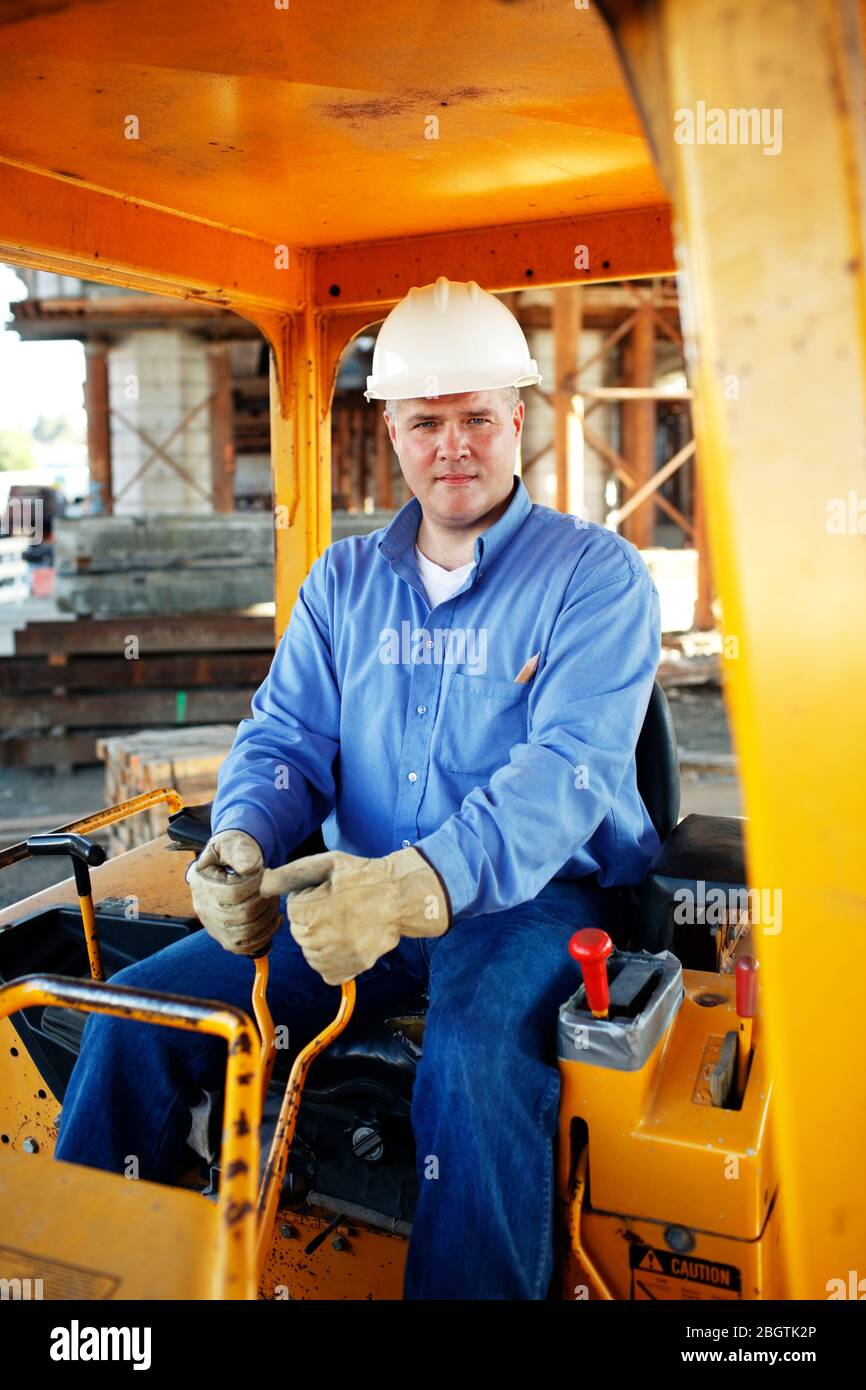 Male construction foreman sitting in a construction loader Stock Photo ...