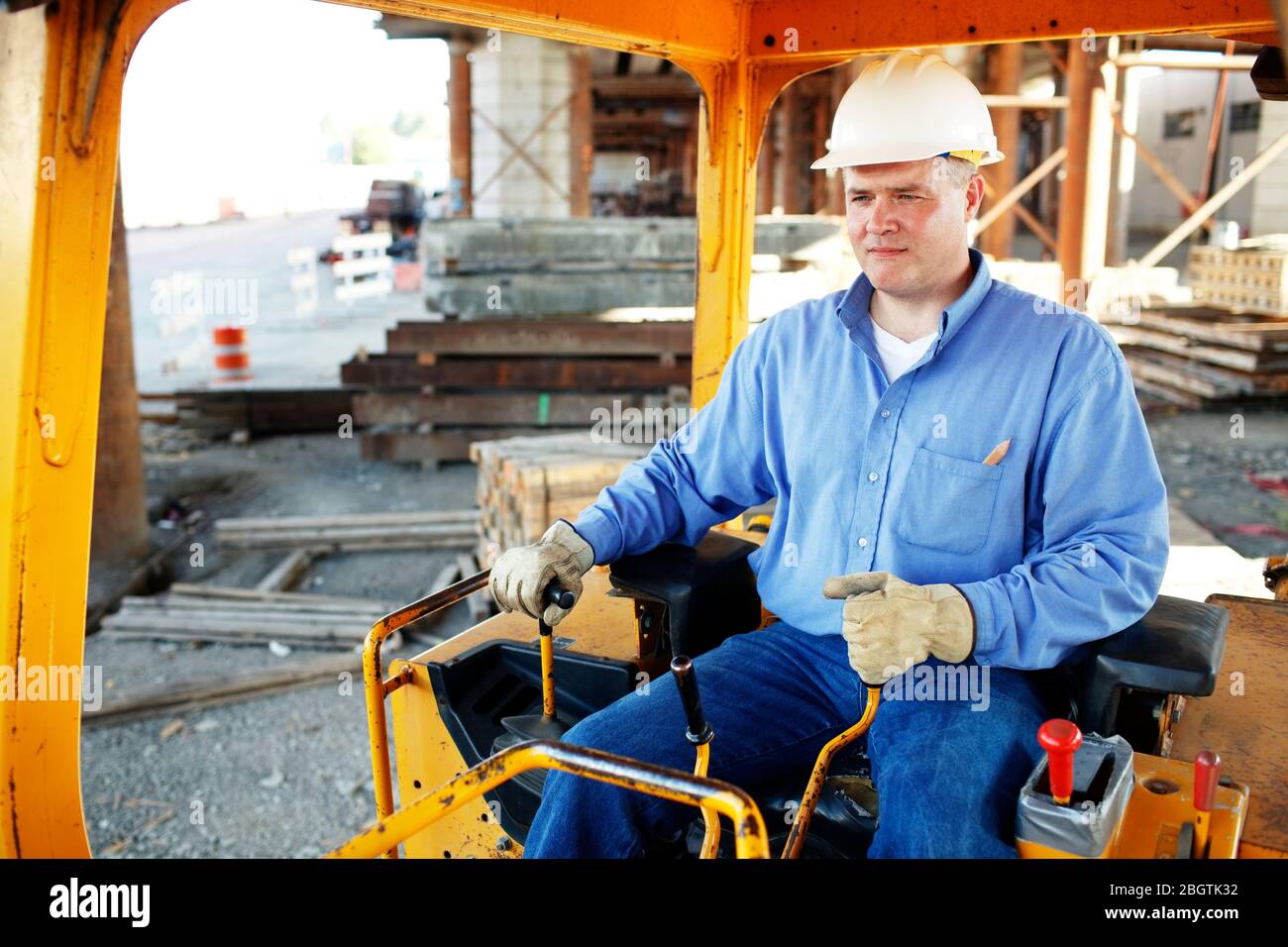 Male construction foreman sitting in a construction loarder Stock Photo ...