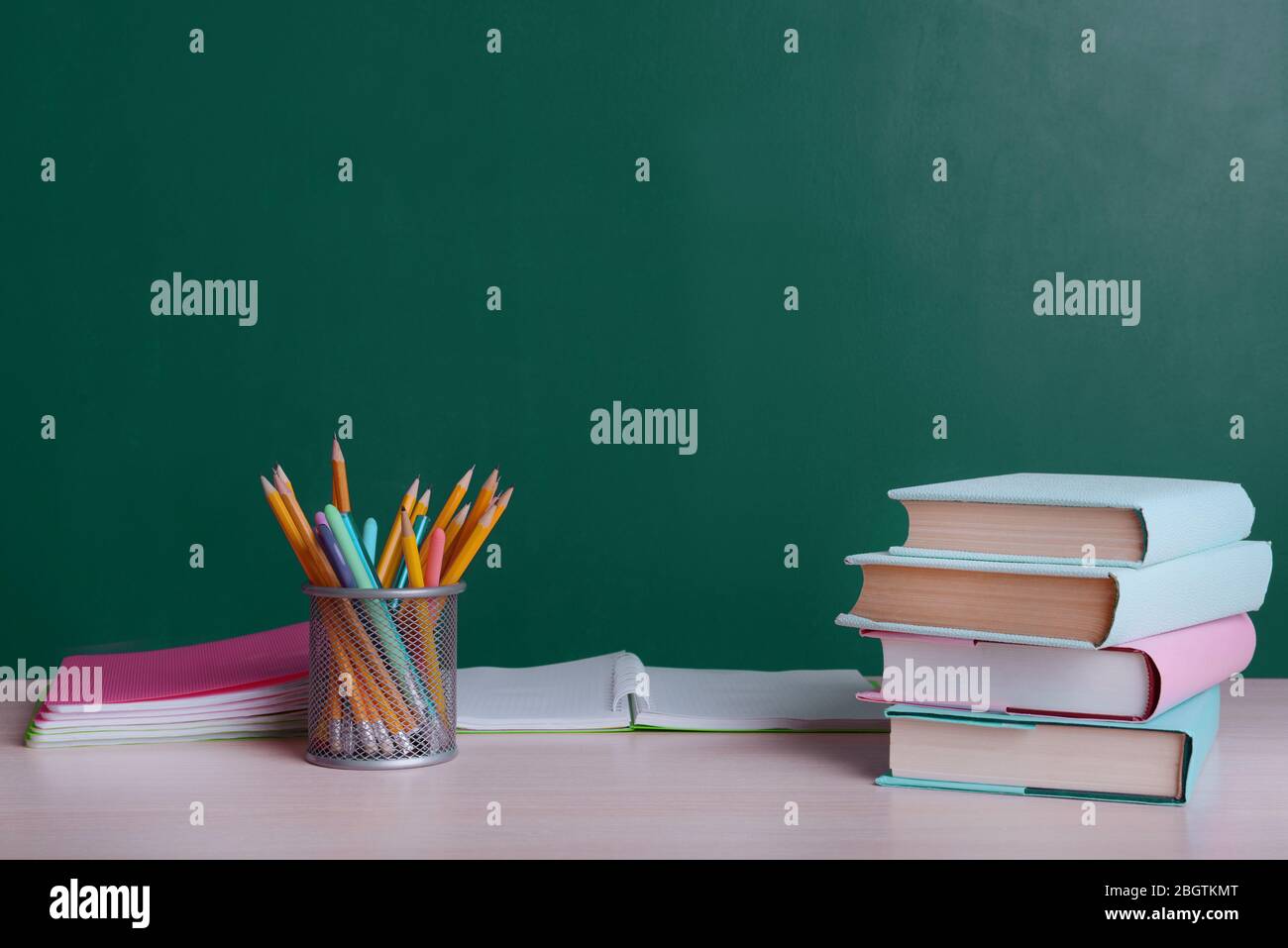 School supplies on table on board background Stock Photo - Alamy
