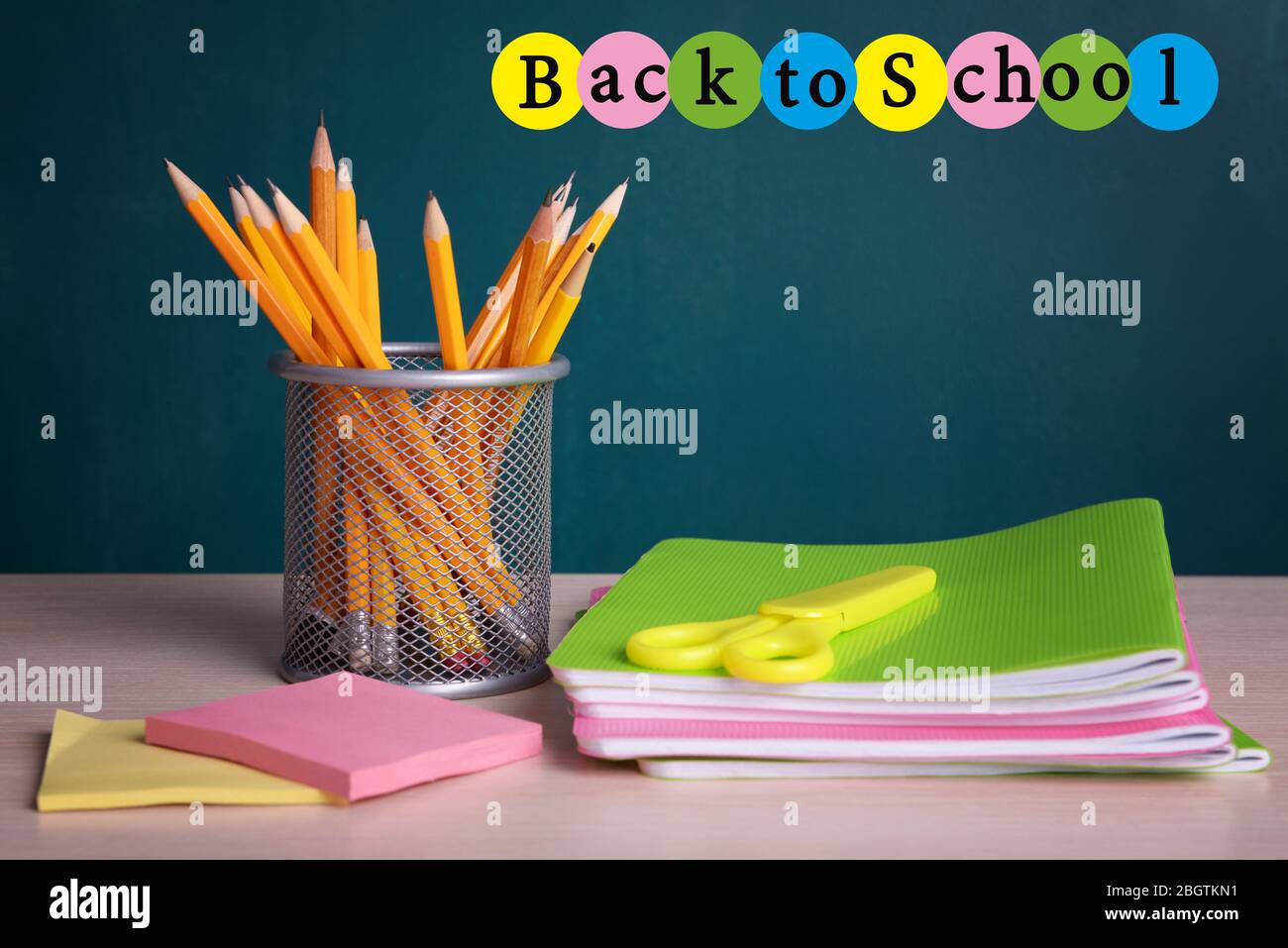 School supplies on table on board background Stock Photo - Alamy