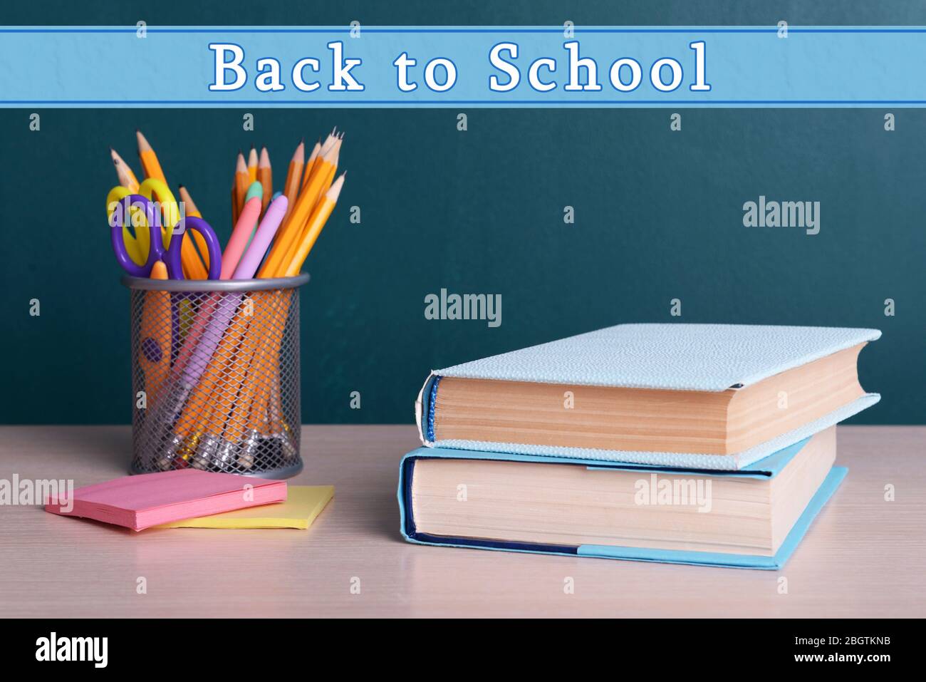School supplies on table on board background Stock Photo - Alamy