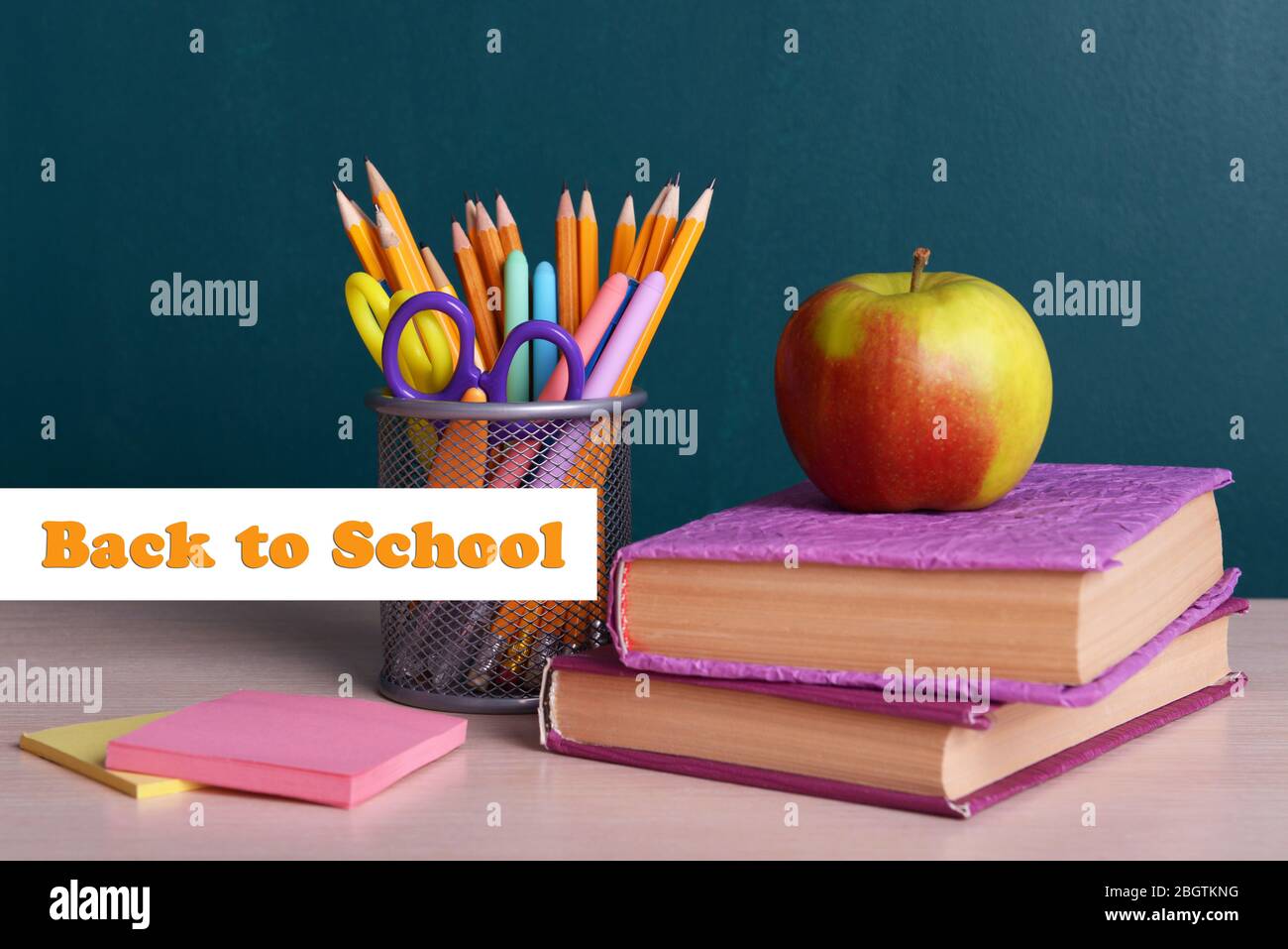 School supplies on table on board background Stock Photo - Alamy