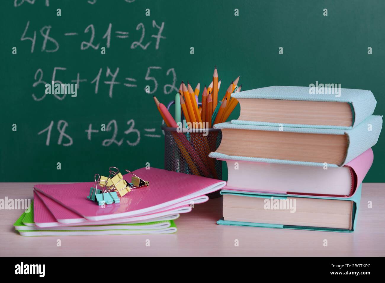 School supplies on table on board background Stock Photo - Alamy